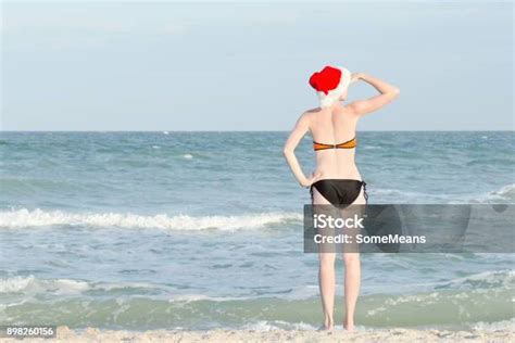산타 모자와 수영복 소녀 거리에 보인다 바다 해안입니다 감탄에 대한 스톡 사진 및 기타 이미지 감탄 거리가 먼 공휴일