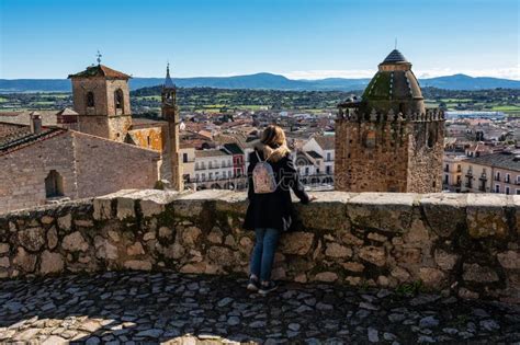 Tourist Woman Leaning Over The Medieval Wall Contemplating The City Of