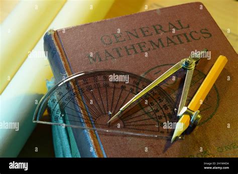 A Closeup Of A General Mathematics School Book And A Compass And