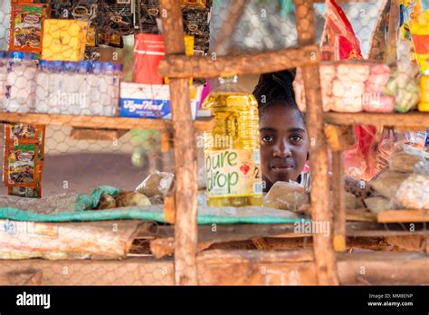 Zambian Woman Peers Through Small Window In Grocery Store Mukuni