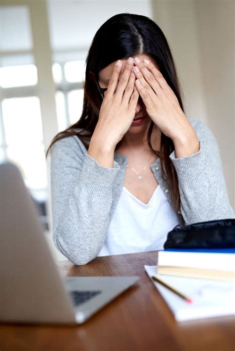 Woman Sitting At Work Desk With Head In Hands Stock Image Image Of
