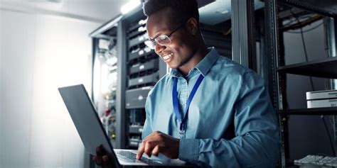 Premium Photo | Laptop server room and black man on network for ...