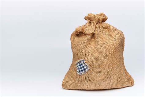 Premium Photo A Filled Bag Of Burlap With A Patch