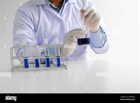 Science Innovative Male Medical Or Scientific Laboratory Researcher Performs Tests With Liquid