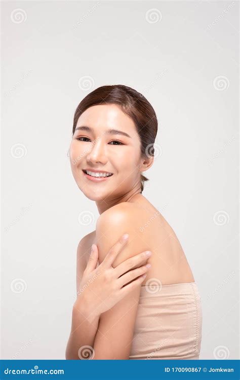 Beautiful Young Asian Woman Looking While Touching Shoulder Stock Image