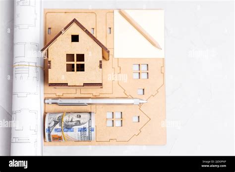 Toy House Model Kit Blueprints Pen Pencil And Paper Note On A Concrete Table Home Renovation
