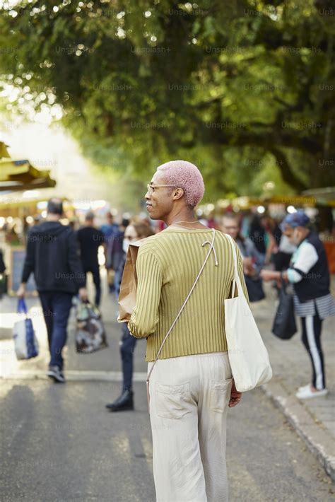 A Man With A Pink Mohawk Walking Down A Street Photo Small Business