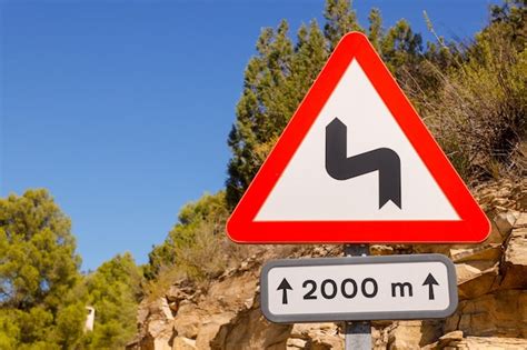 premium photo a road sign marking danger curves