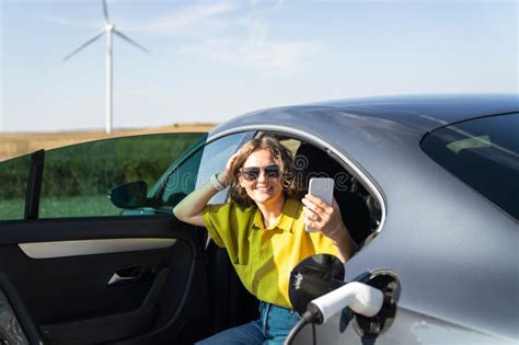Woman With Curve Hairs Wearing Yellow Shirt And Sunglasses Sits Into