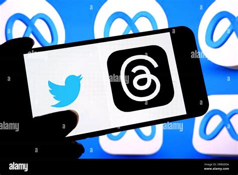 In this photo illustration, a Threads and Twitter logos are seen displayed on a smartphone with ...