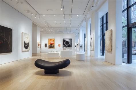 A Modern Art Gallery Featuring Various Abstract Artworks And A Central