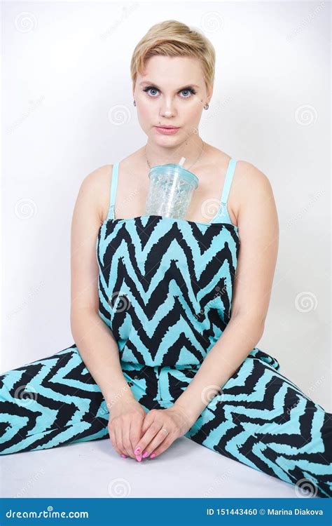 Charming Plus Size Young Woman In Black Blue Jumpsuit With Glass Of