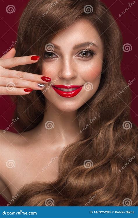 Beautiful Girl With A Classic Makeup Curls Hair And Red Nails