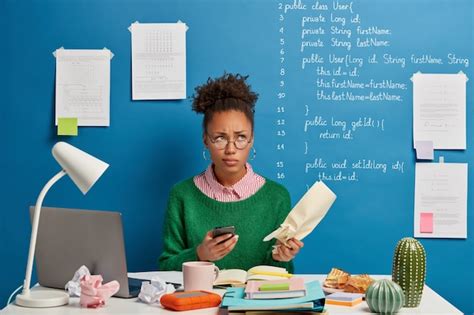Free Photo Pensive Dark Skinned Female Programmer Has Embarrassed Face Expression Tries