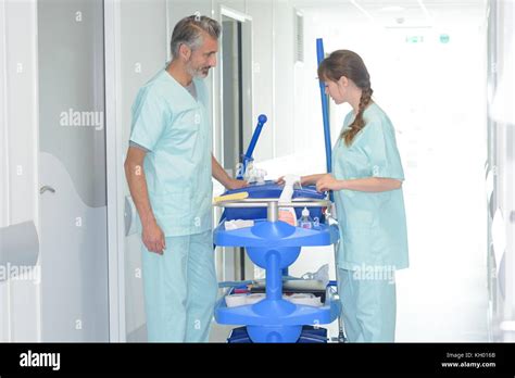 Female And Male Cleaners With Mop And Cleaning Equipment Stock Photo Alamy