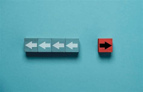Premium Photo Black Arrow On Red Wooden Block Cube Move Out In