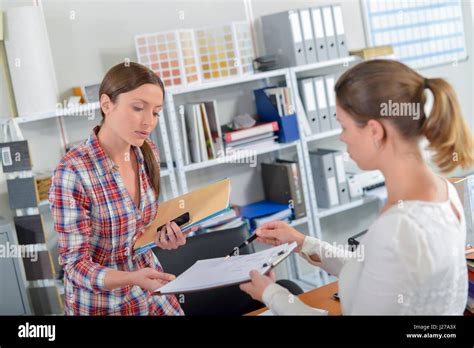 Colleague Handing Over A Clipboard Stock Photo Alamy