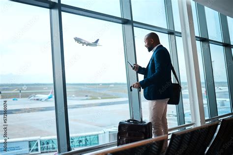 Black Man With Phone Airport Window And Plane Taking Off Checking