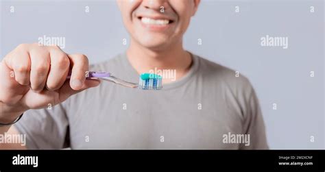 Young Man Showing Toothbrush With Toothpaste Isolated Guy Holding Brush With Toothpaste On
