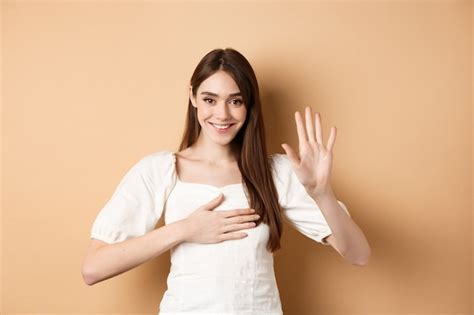 Free Photo Cute Smiling Girl Make Promise Put Hand On Heart And Tell