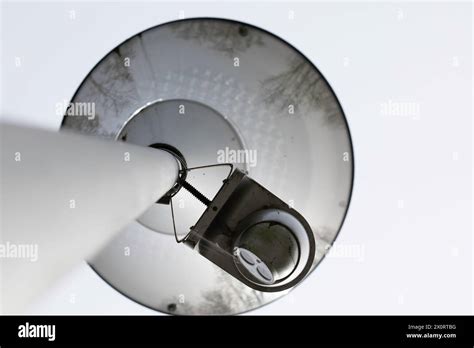 City Surveillance Camera With Movable Head Placed Under The Lamp Shade