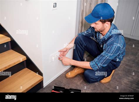 Professional Electrician In Workwear Checking Or Measuring Voltage Of Socket Stock Photo Alamy
