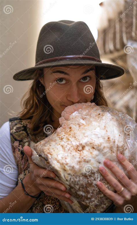 Young Woman Holding Mycelium Substrate With Lion Mane Mushrooms And