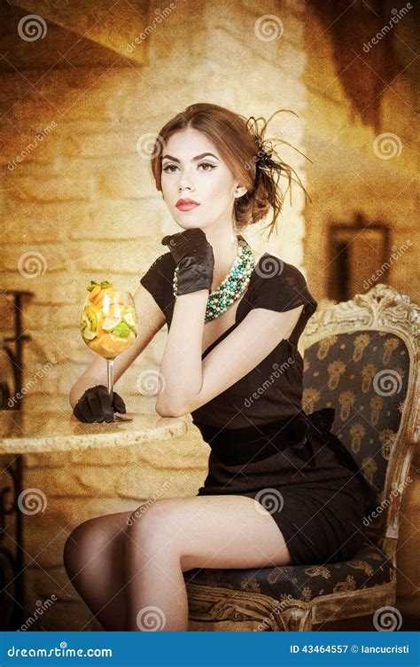 Fashionable Attractive Young Woman In Black Dress Sitting In Restaurant