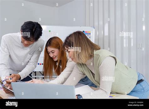 Collaborative UX UI Design Team Working On Creative Project In Modern Office Environment Stock
