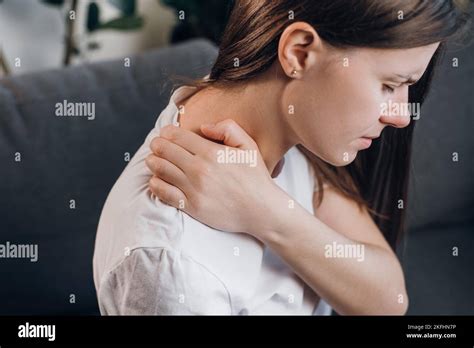 Close Up Of Tired Unhappy Young Caucasian Woman Massaging Rubbing Stiff