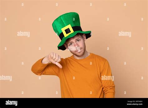 Attractive Young Guy With A Big Green Hat On A Yellow Background Stock