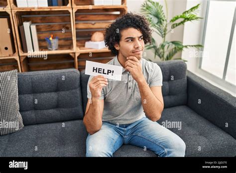 Hispanic Man With Curly Hair Asking For Help Serious Face Thinking