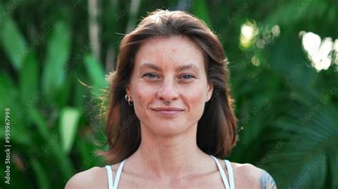 Beautiful Portrait Of Happy Smiling Woman Looking At Camera On Green