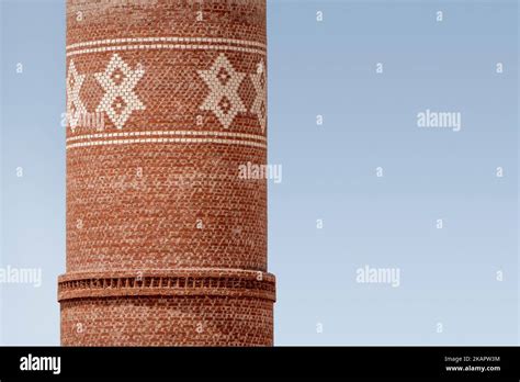 Industrial Chimneys Made Of Patterned Red Bricks On The Banks Of The