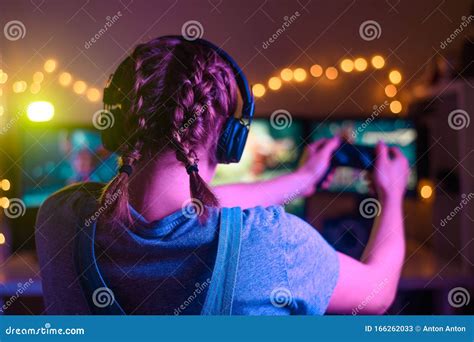 Gamer Girl With A Joystick Plays On A Console Or Computer Using A