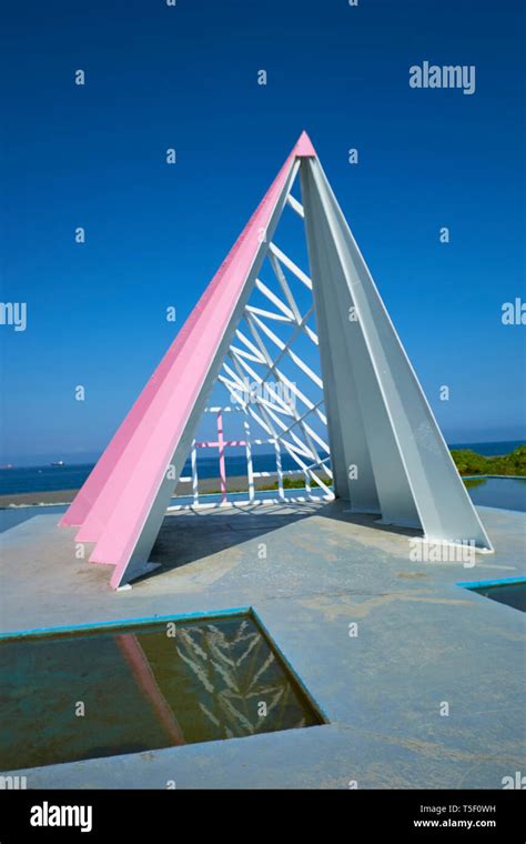 A Modern Pink Sculpture Loosely Modeled As A Church At The Beach On