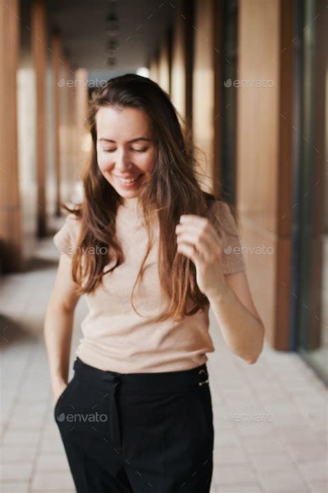 Close Up Candid Portrait Of A Young Brunette Millennial Woman Smiling
