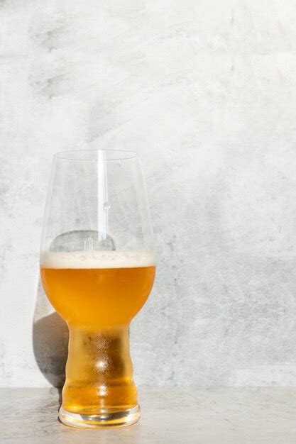 Premium Photo Glass Cup Served With Ipa Beer And A Bottle And A Can