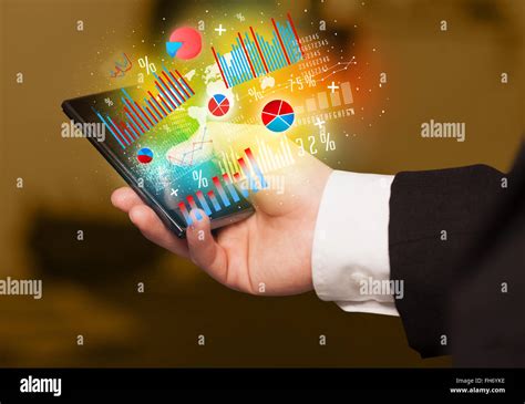 Business Man Holding Smartphone With Chart Symbols Stock Photo Alamy