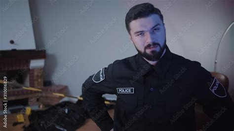 Portrait Of Tired Caucasian Police Officer Rubbing Eyes And Looking At