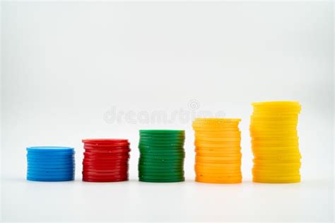 Stack Of Colorful Coins With Trading Chart In Financial Concepts And