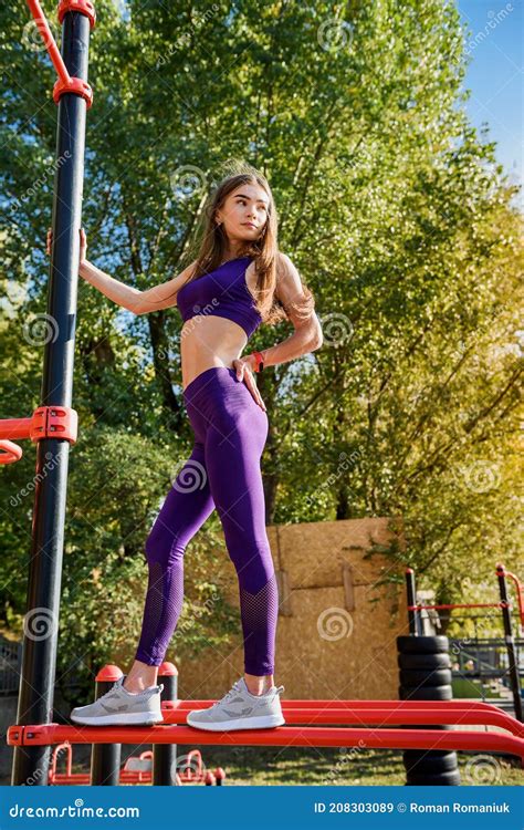 Beautiful Slim Girl In Sport Sportswear Makes Morning Exercise At