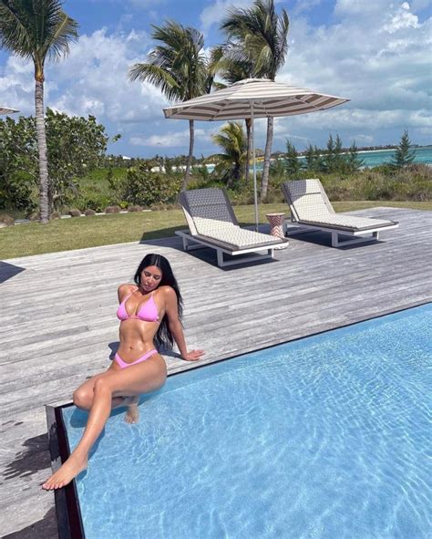 Kim Kardashian Strikes Sexy Poses Poolside In Teeny Pink Bikini