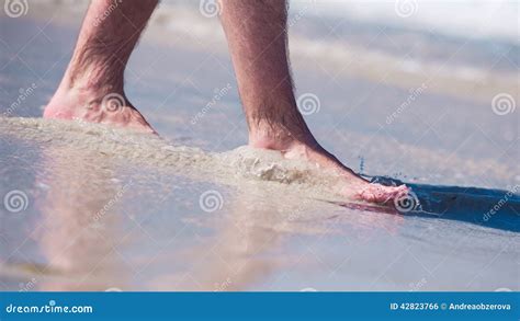 Male Bare Feet In A Warm Sand, Man Taking A Walk On A Sunny Beach With ...