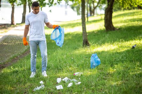 Premium Photo Man Standing Looking At Garbage On Grass