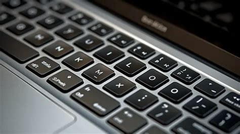 Macro Shot Of Black Laptop Keyboard Keys Against A Backdrop Of Light
