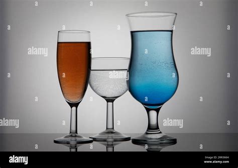 A Still Life Of Three Glasses Filled With Different Coloured Liquid