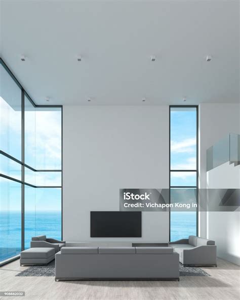 현대 인테리어 거실 소파와 이중 공간 비치 창 보기를 설정합니다 흰색 벽 이랑 램프 Tv 사진 프레임에 대 한 나무 바닥 로프트 스타일 바다 보기 여름 3d 렌더링 로프트