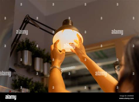 Hand Woman Changing With New LED Lamp Light Bulb Power Saving Concept