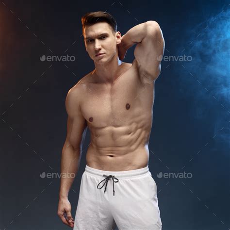 Strong Athletic Man Fitness Model Showing His Perfect Body Isolated